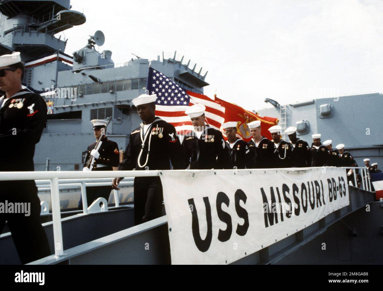 The crew of the USS MISSOURI (BB 63) marches down the gang plank at the ...