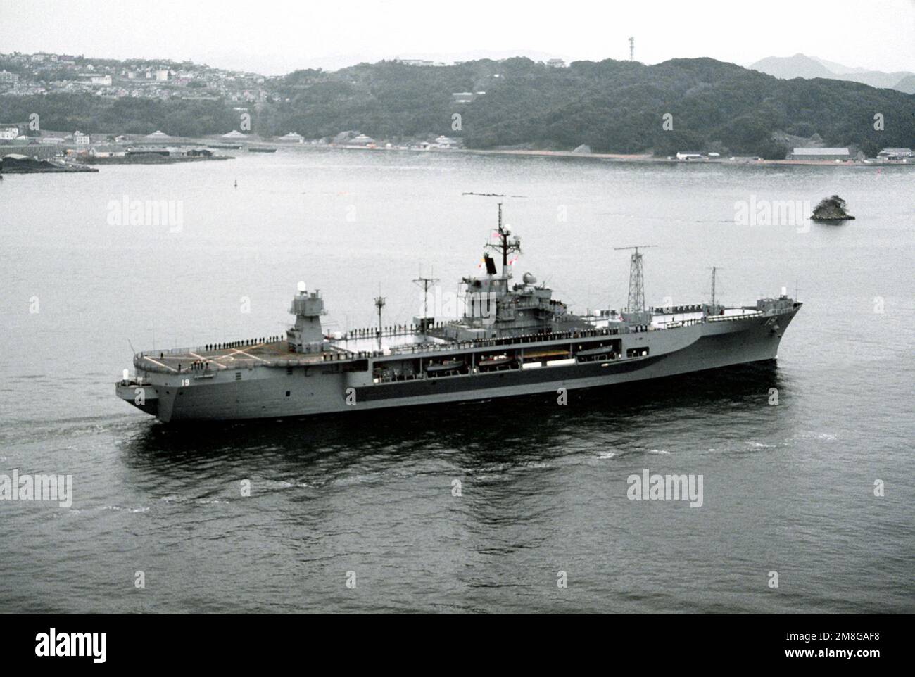 Sailors man the rails aboard the amphibious command ship USS BLUE RIDGE ...