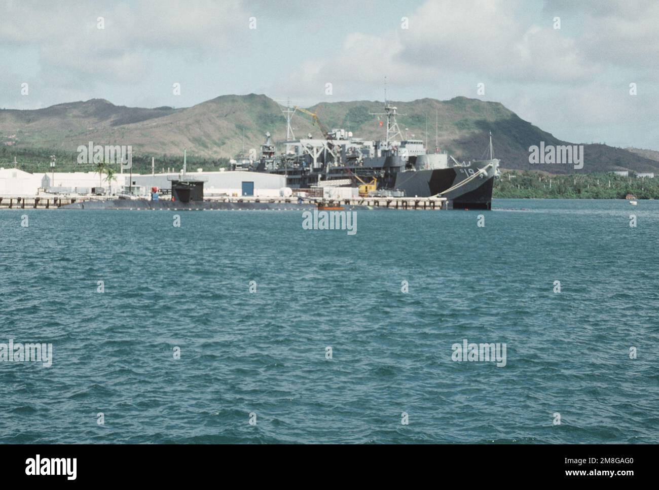 The submarine tender USS PROTEUS (AS-19) and an unidentified submarine ...