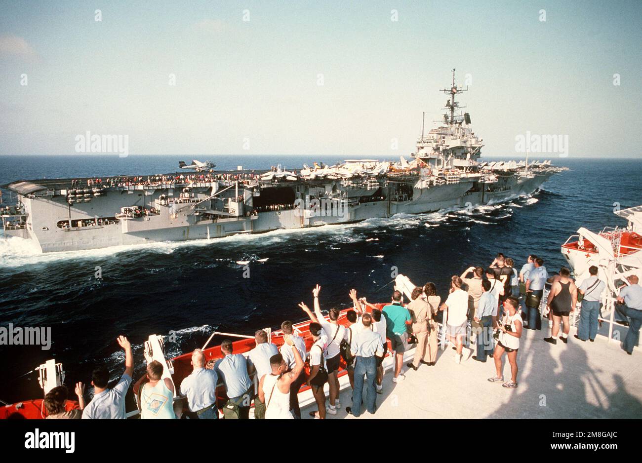 The aircraft carrier USS INDEPENDENCE (CV-62) is greeted by the crew of ...