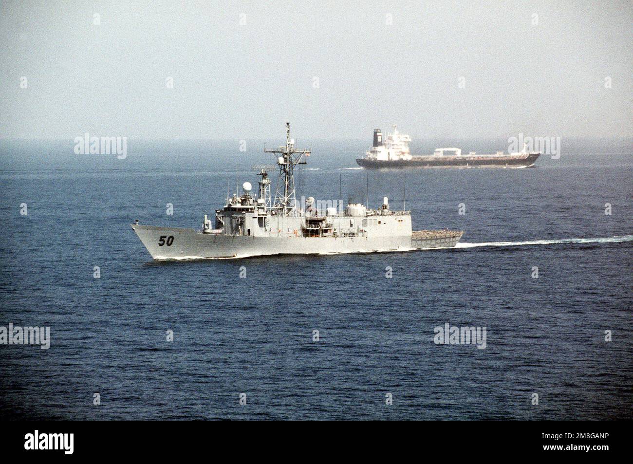 A port view of the guided missile frigate USS TAYLOR (FFG-50) as it ...