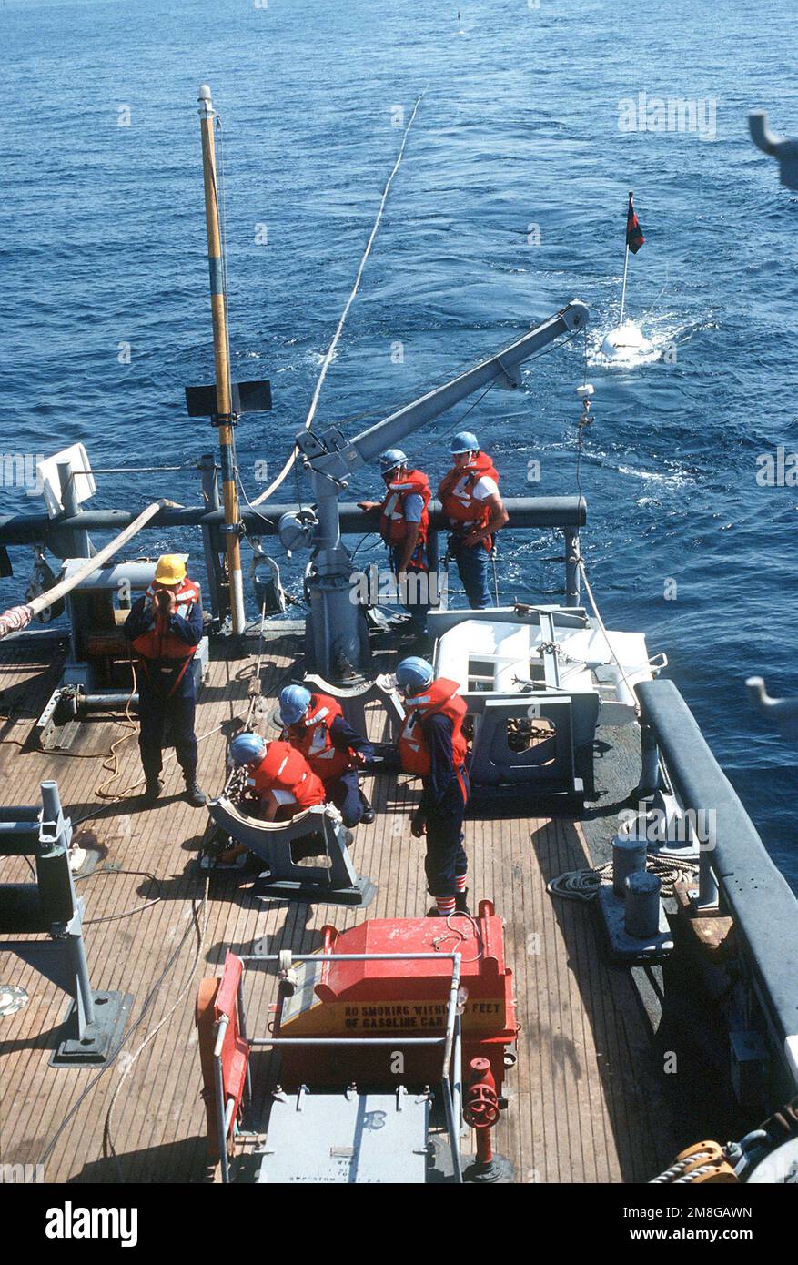 A minesweeping float is towed behind an ocean minesweeper during ...