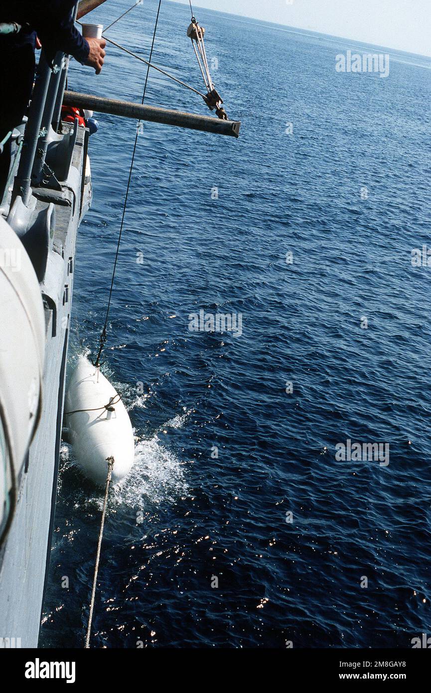 A minesweeping float is lowered from an ocean minesweeper in ...
