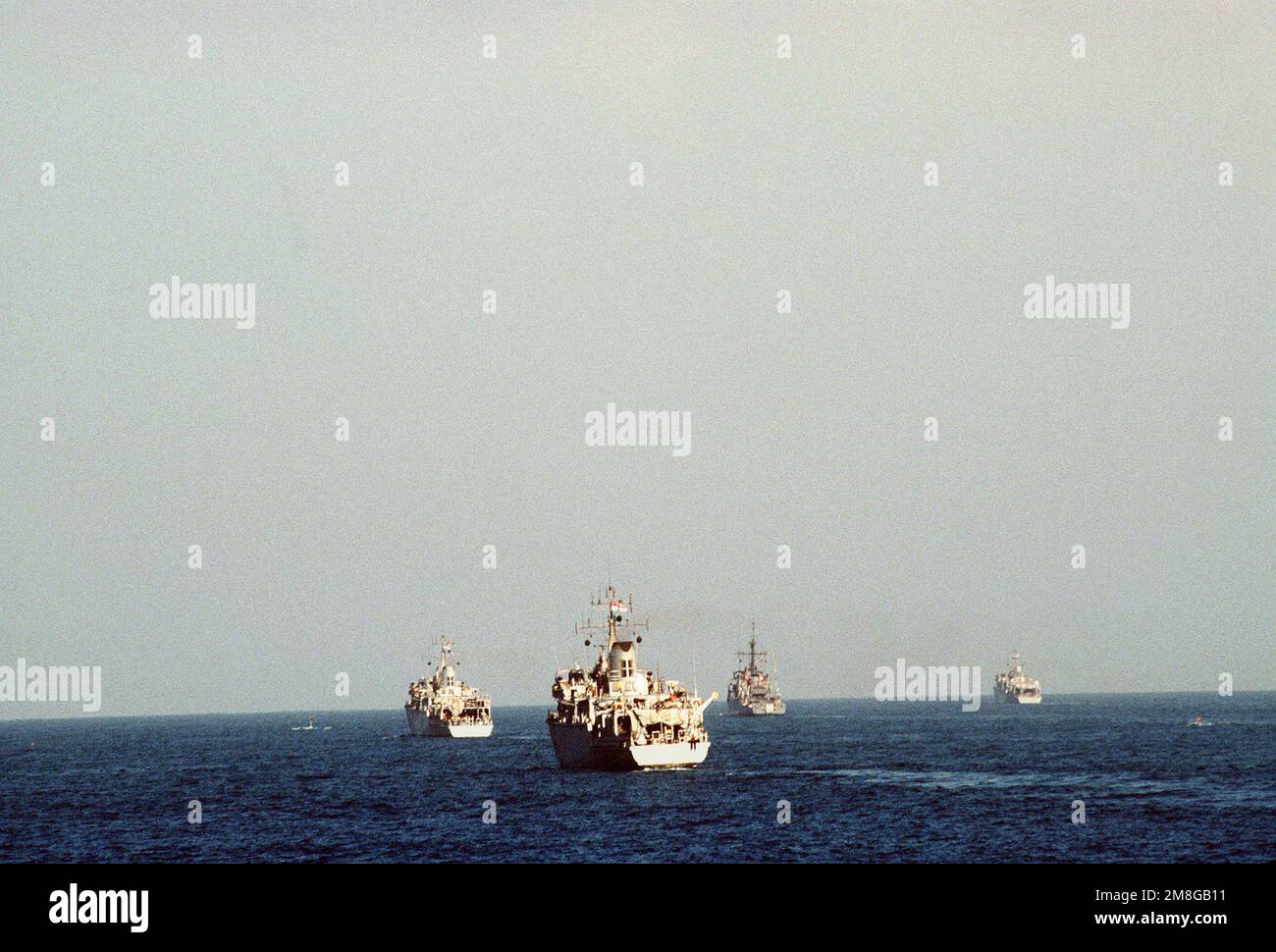 British coastal minesweepers and a U.S. Navy ocean minesweeper travel ...