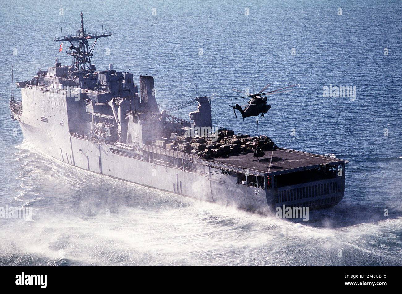 A CH-53E Super Stallion helicopter lifts cargo from the deck of the ...