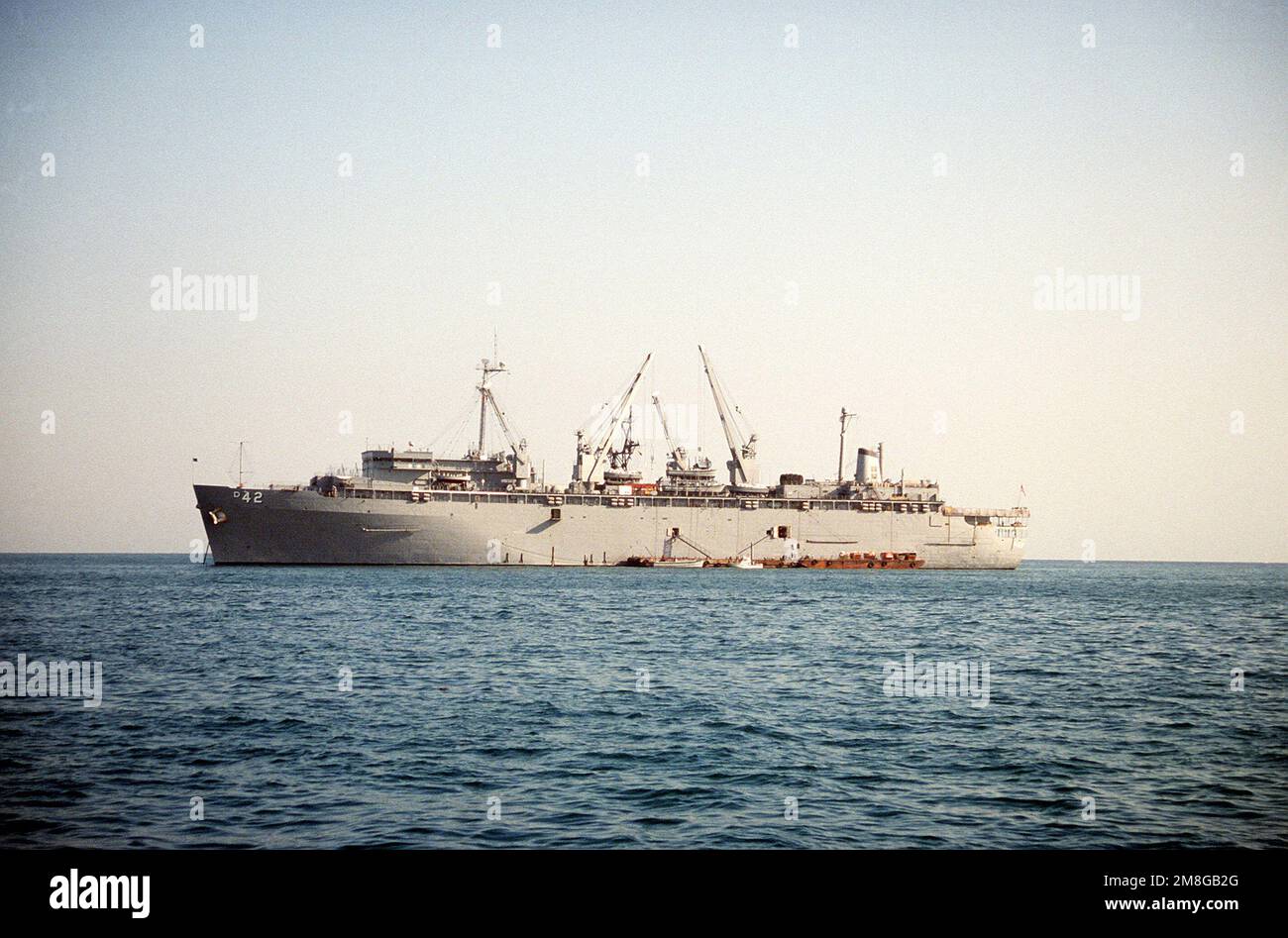 A port view of the destroyer tender USS ACADIA (AD-42) at anchor during ...