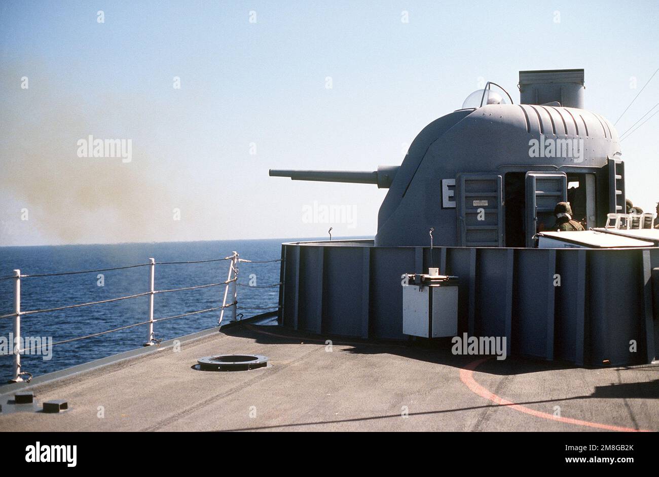 A Mark 33 3-inch 50-caliber gun is fired aboard a U.S. Navy ship during ...