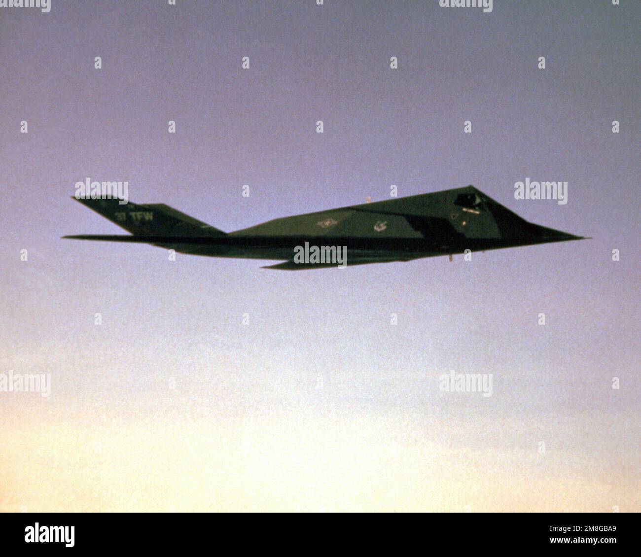 An air-to-air right side view of an F-117A stealth fighter aircraft of ...