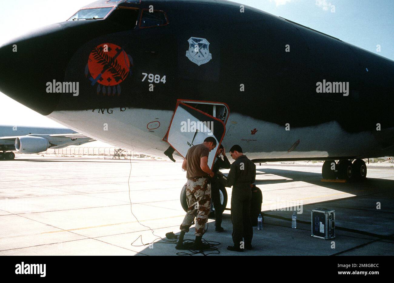 A flight crew member confers with the pilots of a KC-135A Stratotanker ...