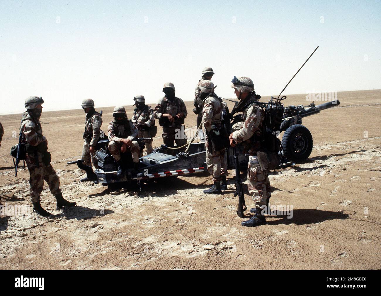Soldiers take a break around an M-102 105mm towed howitzer during ...