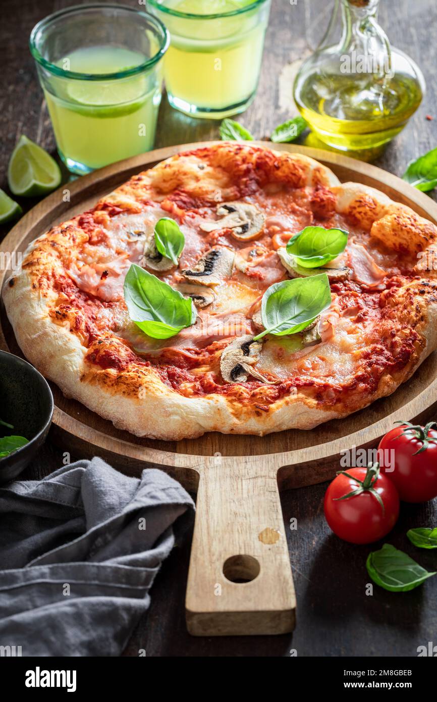 Homemade Capricciosa pizza with cheese, ham and mushrooms. Classic ...