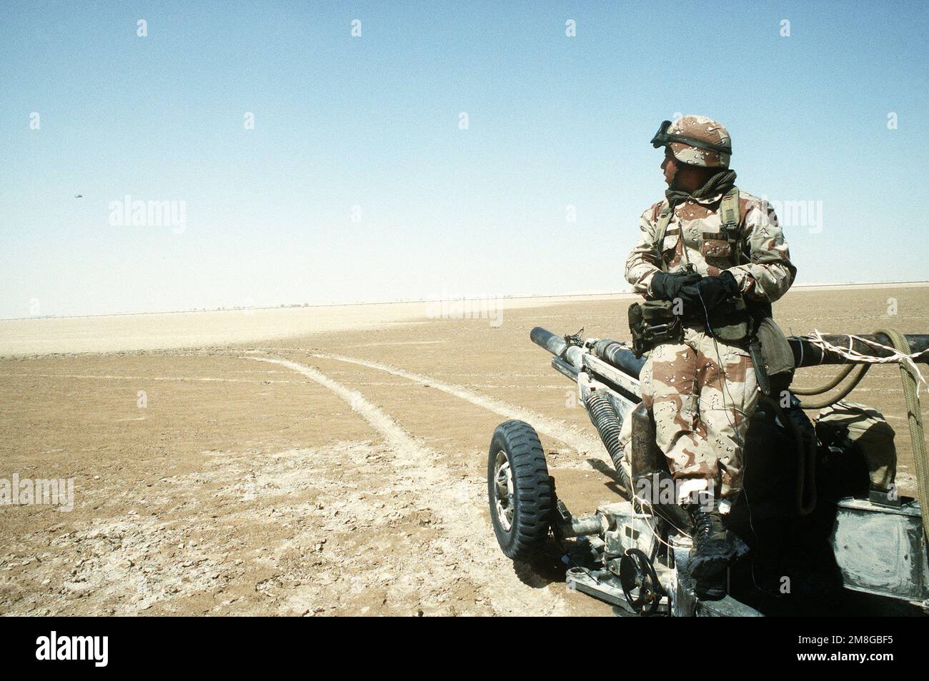 A member of C Btry., 1ST Bn., 319th Air Field Arty. Regt., sits on the ...