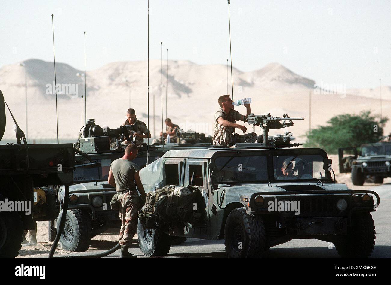 A machine gunner takes a break from manning his M-2 .50-caliber machine ...