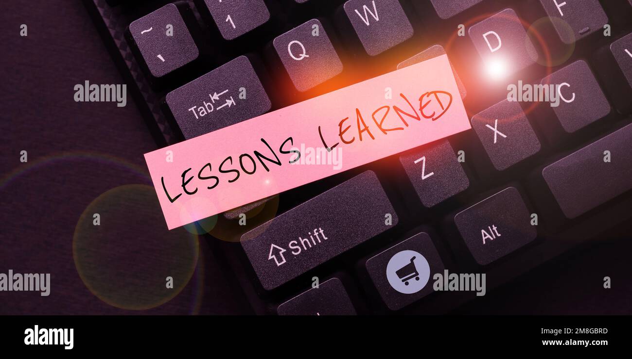 Hand writing sign Lessons Learned. Business idea Promote share and use knowledge derived from ...