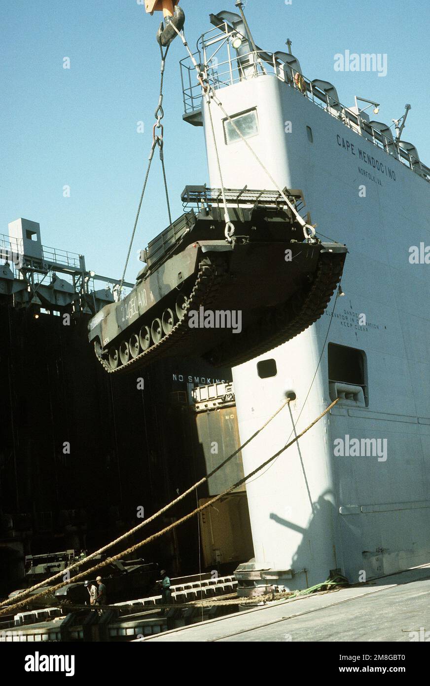 A crane lifts an M-1A1 Abrams main battle tank from the Ready Reserve ...