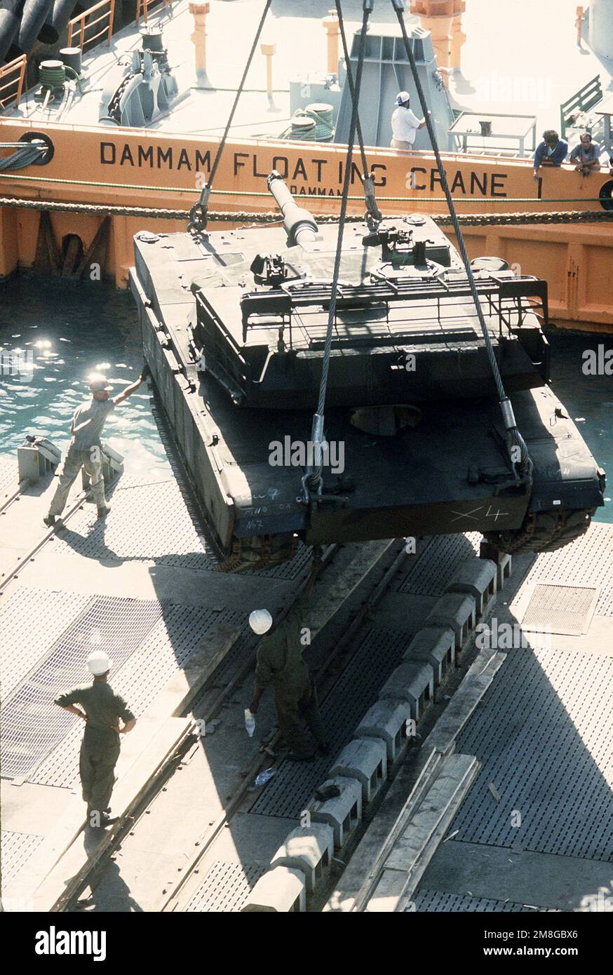 A crane lifts an M-1A1 Abrams main battle tank from the Ready Reserve ...