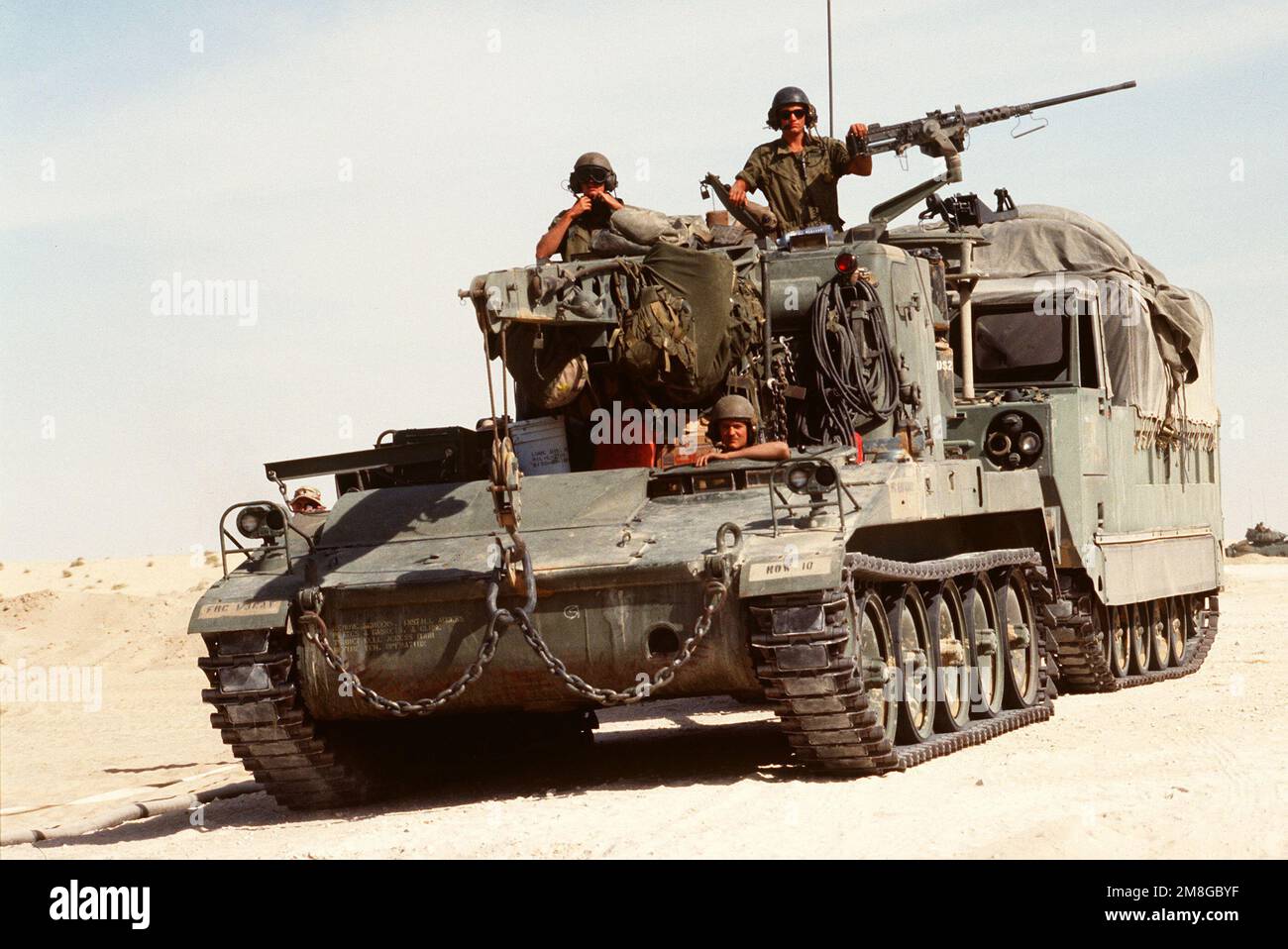 An M-578 light armored recovery vehicle tows an M-548 tracked cargo carrier during Operation ...