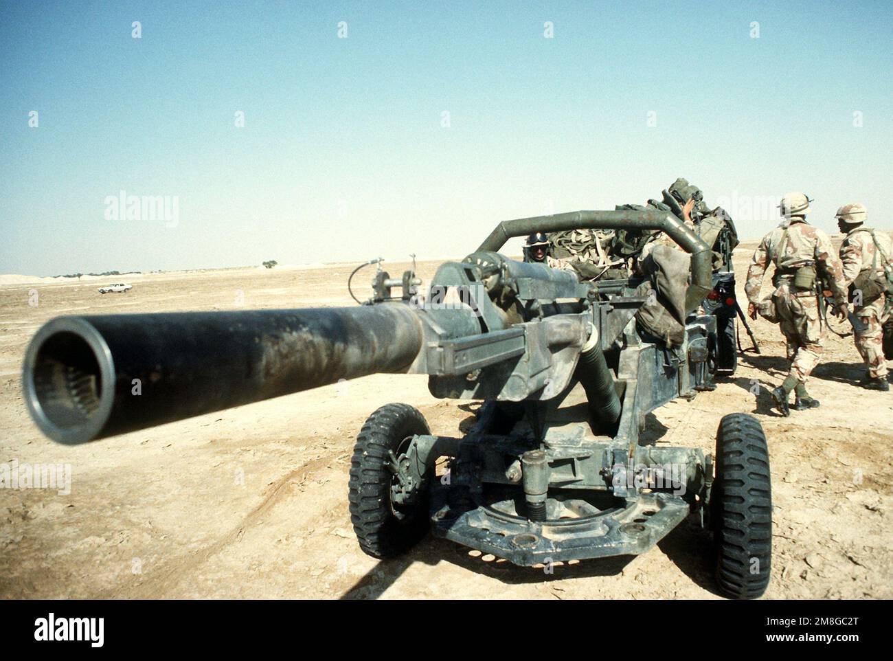 An M-102 105mm towed howitzer stands ready for a heavy artillery ...