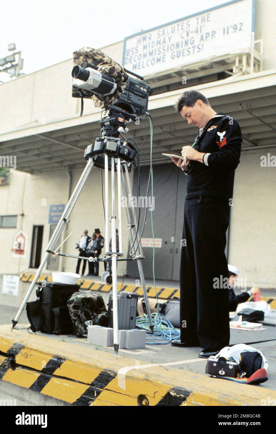 A Photographer's Mate 1ST Class (PH1) is captured on film making out ...