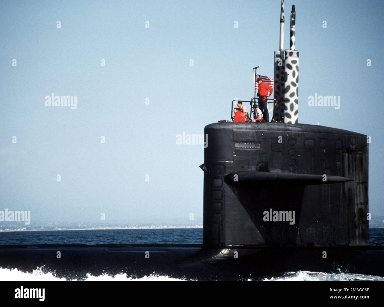 Crew members man the sail of the nuclear-powered attack submarine USS ...