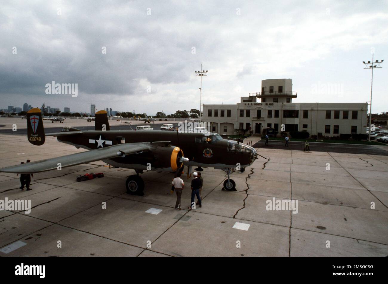 Onlookers check out a restored B-25 Mitchell bomber parked on the air ...