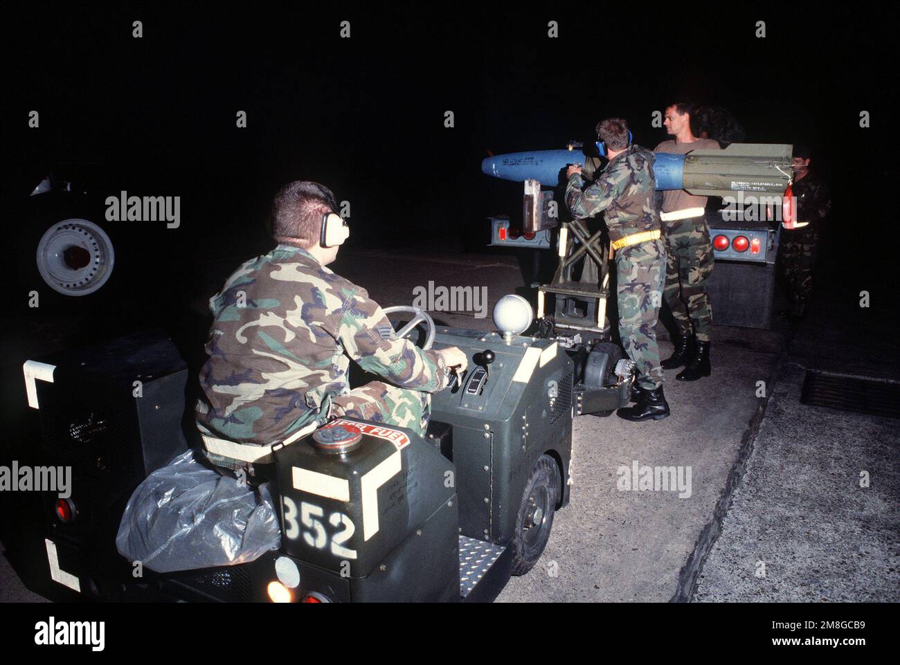 Members of the 2nd Munitions Maintenance Squadron secure a BDU-50 high ...
