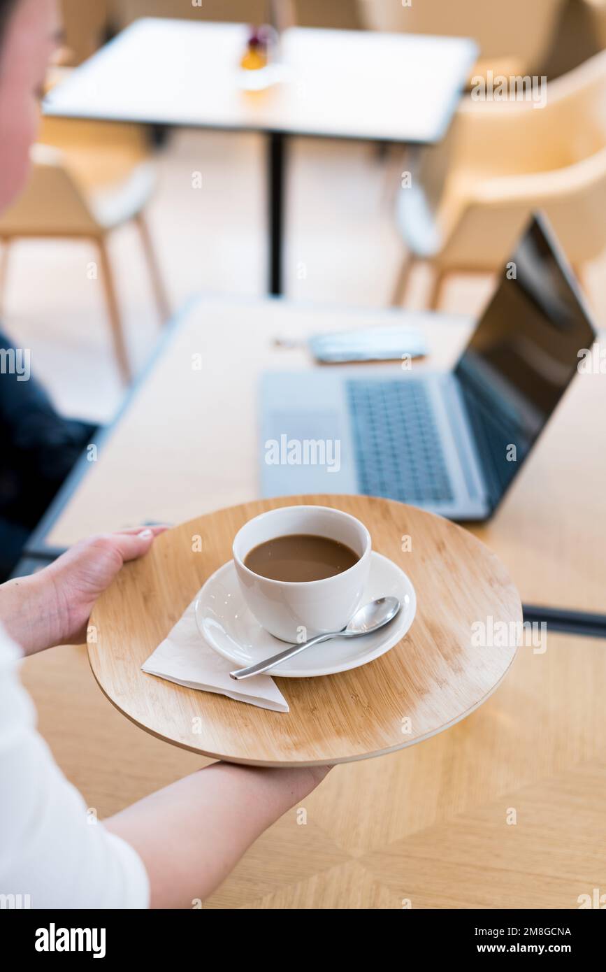 The waiter brought the customer coffee Stock Photo - Alamy