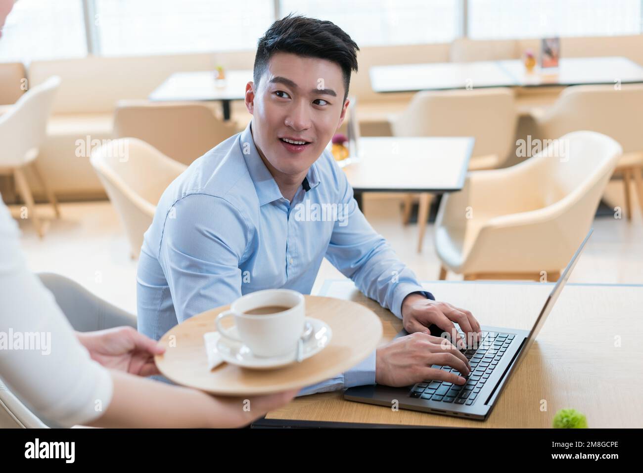 The waiter brought the customer coffee Stock Photo - Alamy