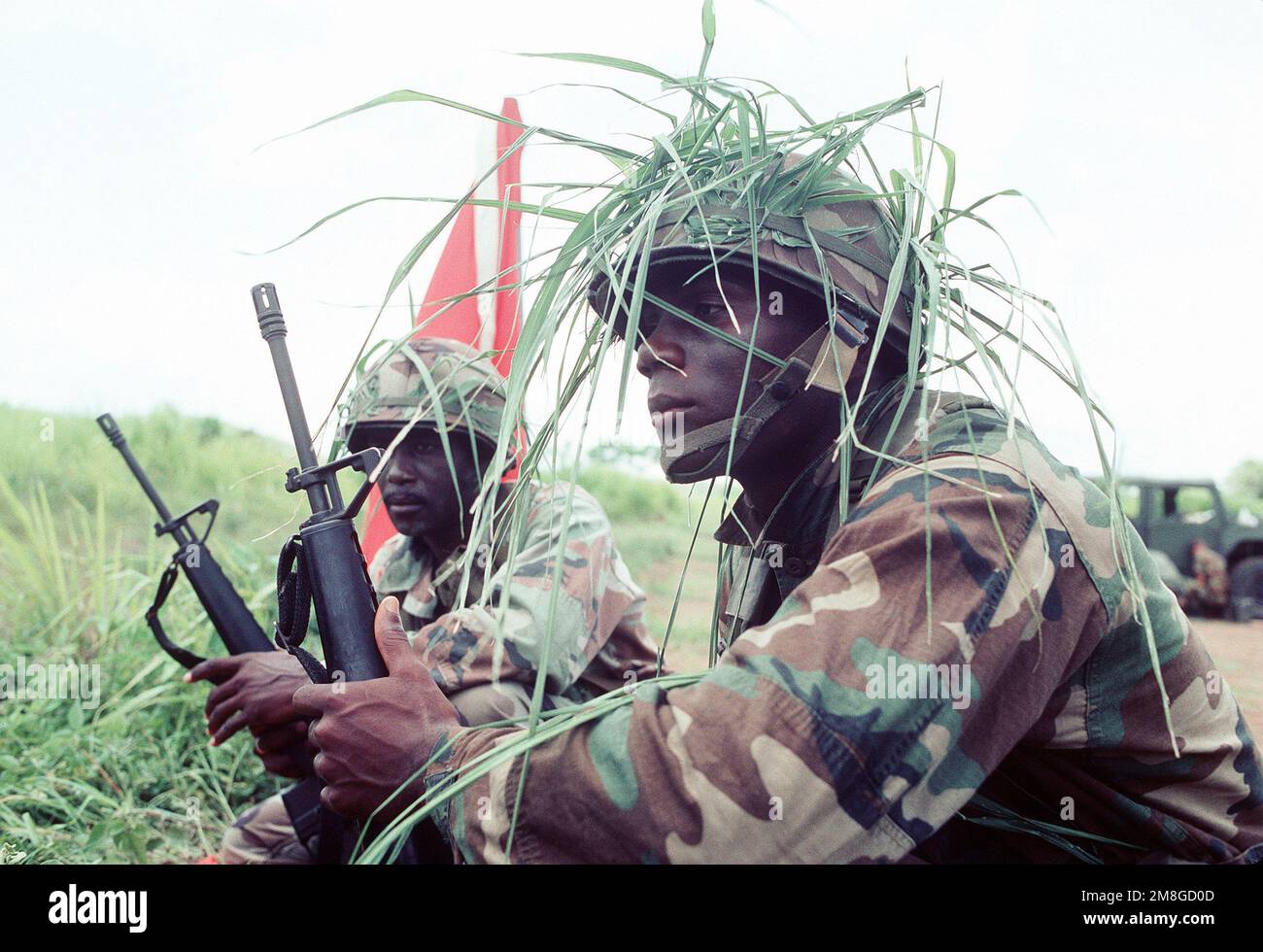 Soldiers armed with M-16A1 rifles maintain their positions during ...