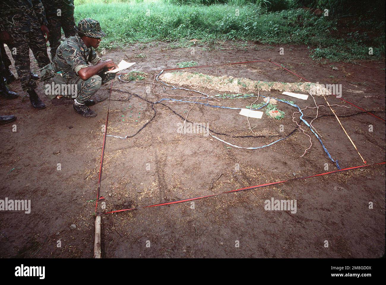 A soldier from the Guyana Defense Forces consults a makeshift tactical ...