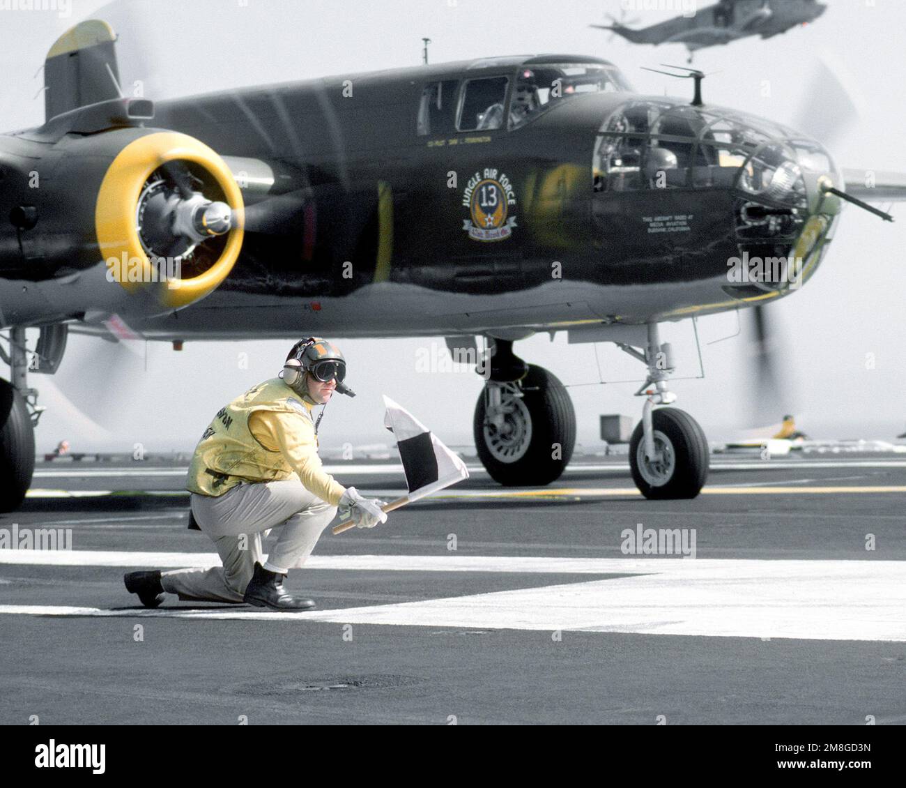 The launch officer aboard the aircraft carrier USS RANGER (CV-61) gives ...