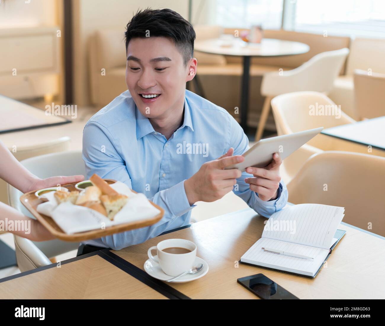 The waiter brought the customer in the afternoon tea Stock Photo - Alamy