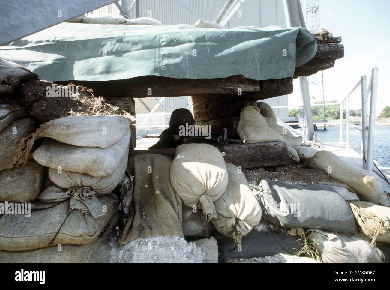 A Marine of the Security Force Company stands guard with an M-16A2 ...