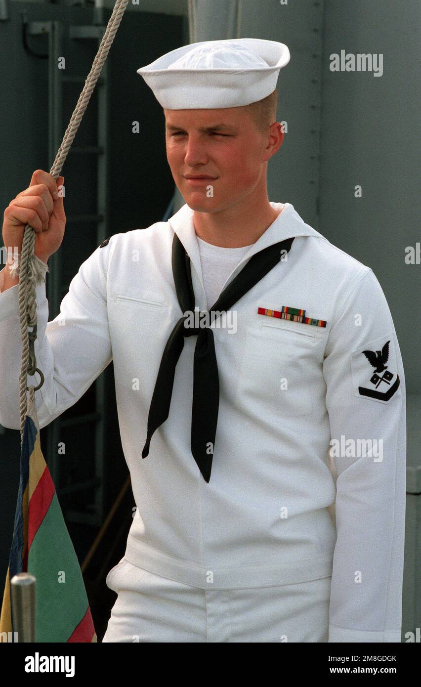 A third class signalman stands by to block signal flags on the bridge ...
