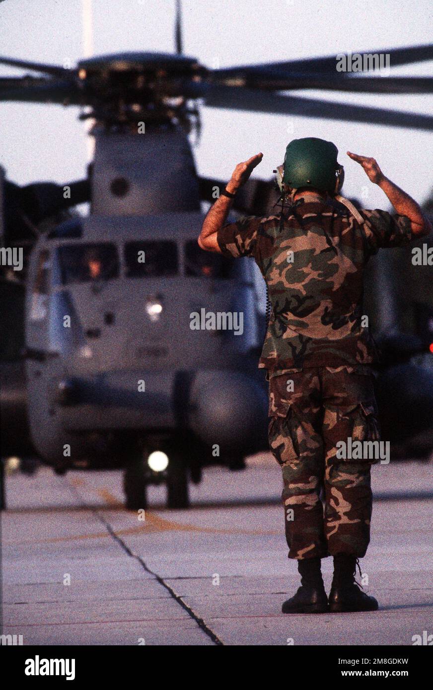 A member of the 20th Aircraft Maintenance Unit uses hand signals to ...