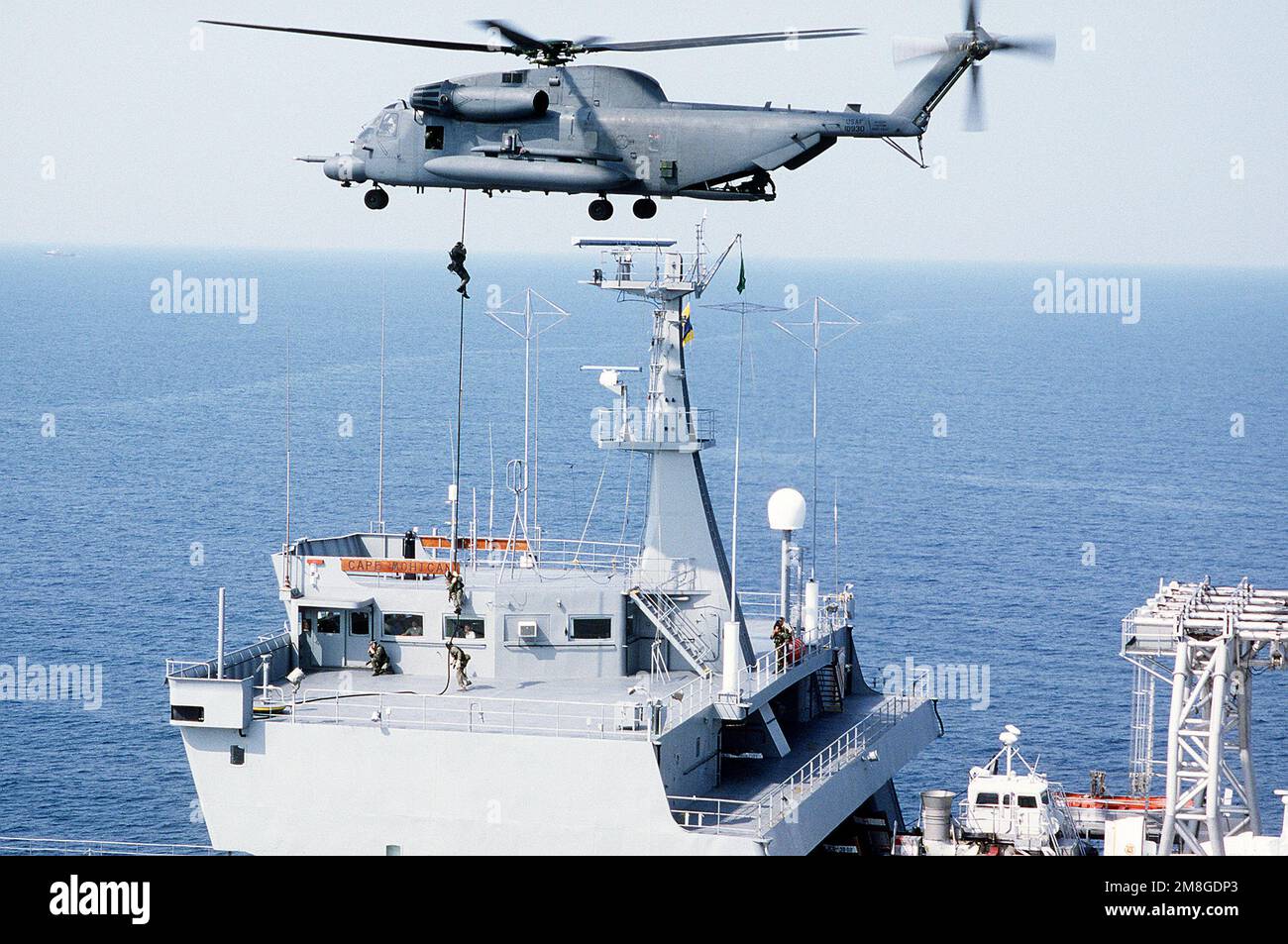 Members of a Navy Sea-Air-Land (SEAL) team fast-rope from a 20th ...