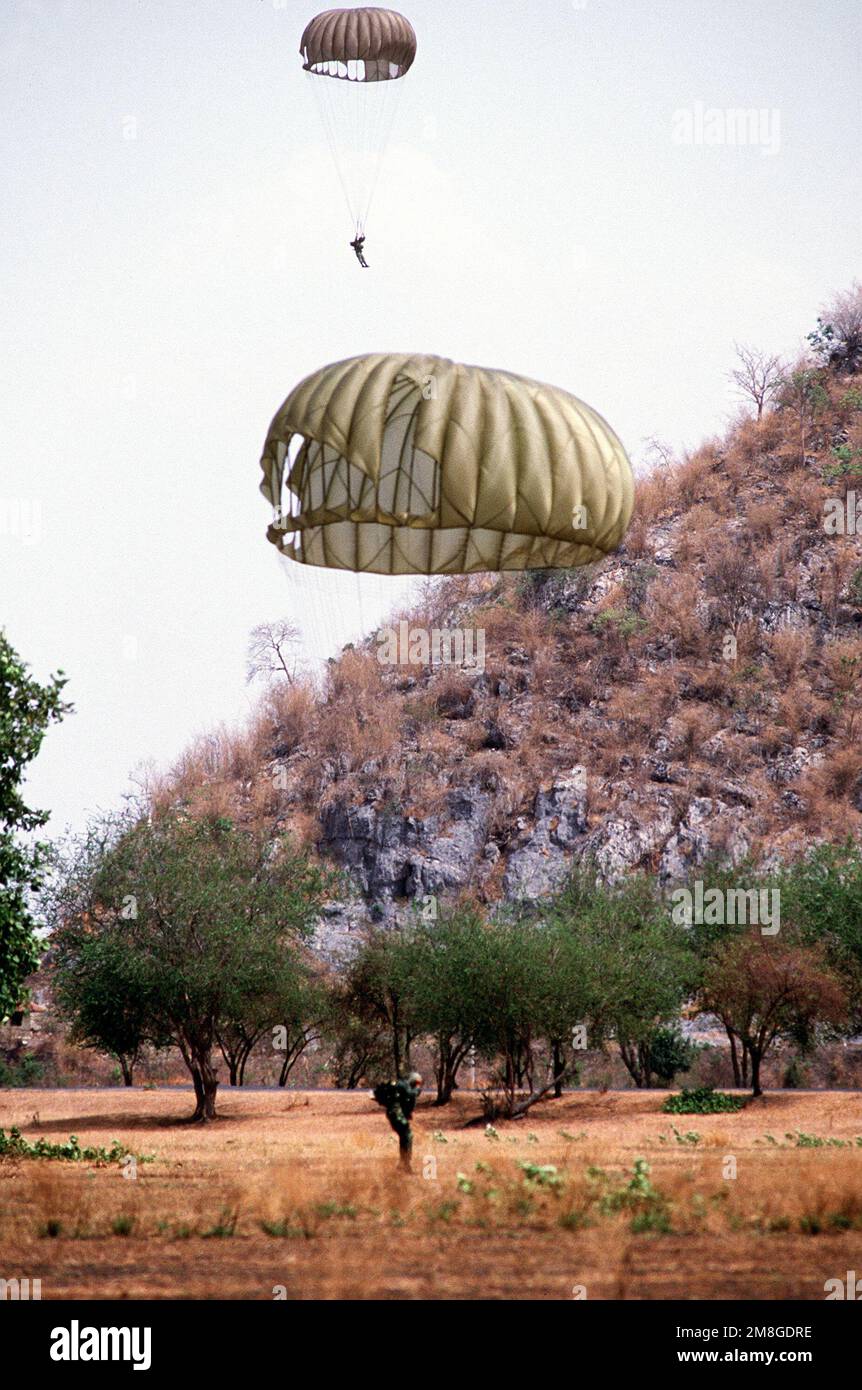 Airborne troops land after jumping from an Air Force C-130 Hercules ...