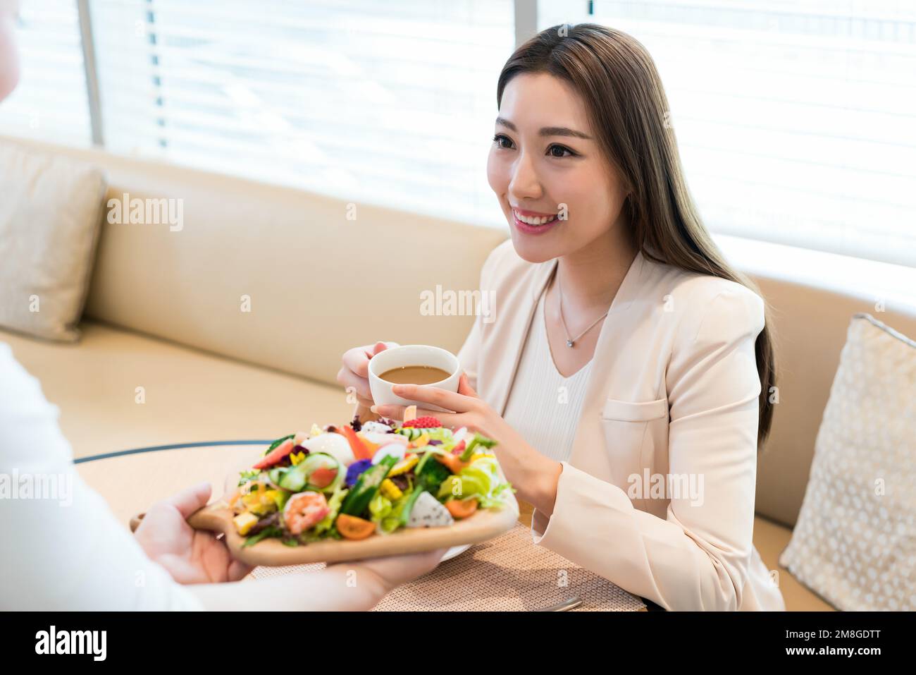 The waiter brought the customer a salad Stock Photo - Alamy