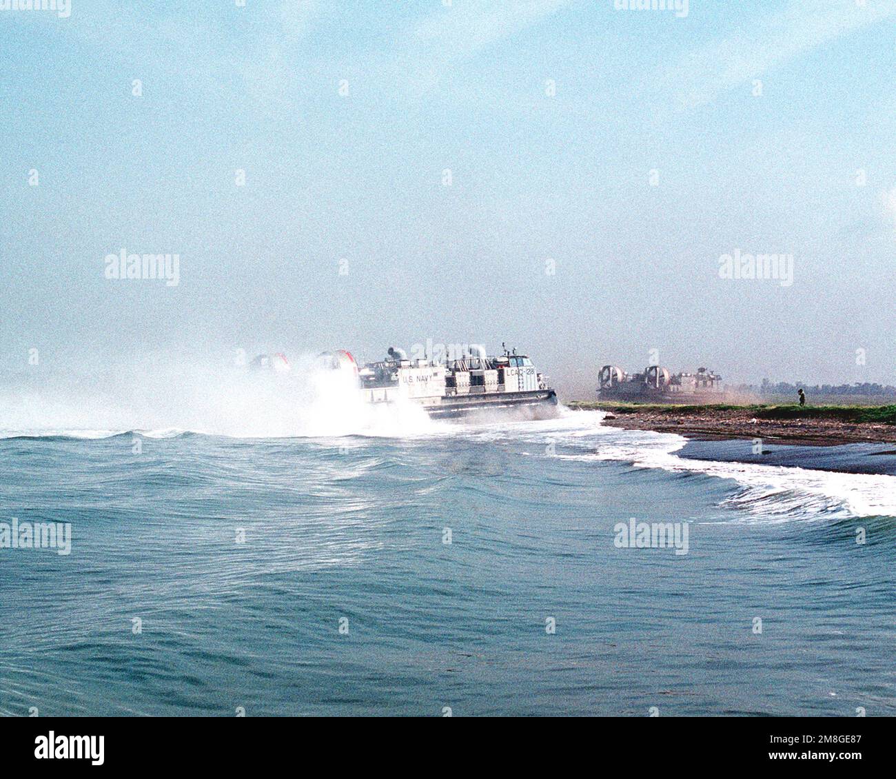 Air-cushion landing craft LCAC-28 emerges from the surf during exercise ...