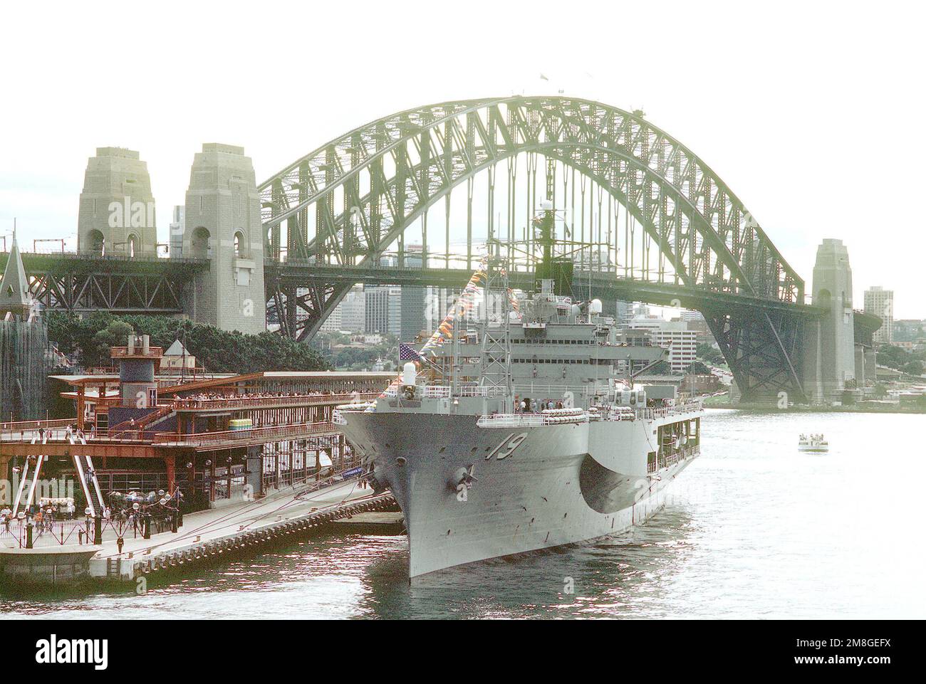 A port bow view of the amphibious command ship USS BLUE RIDGE (LCC-19) moored at a pier. The ...