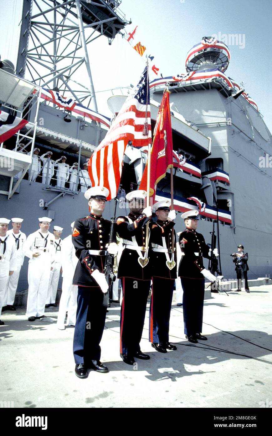 A U.S. Marine Corps color guard stands at attention during the ...