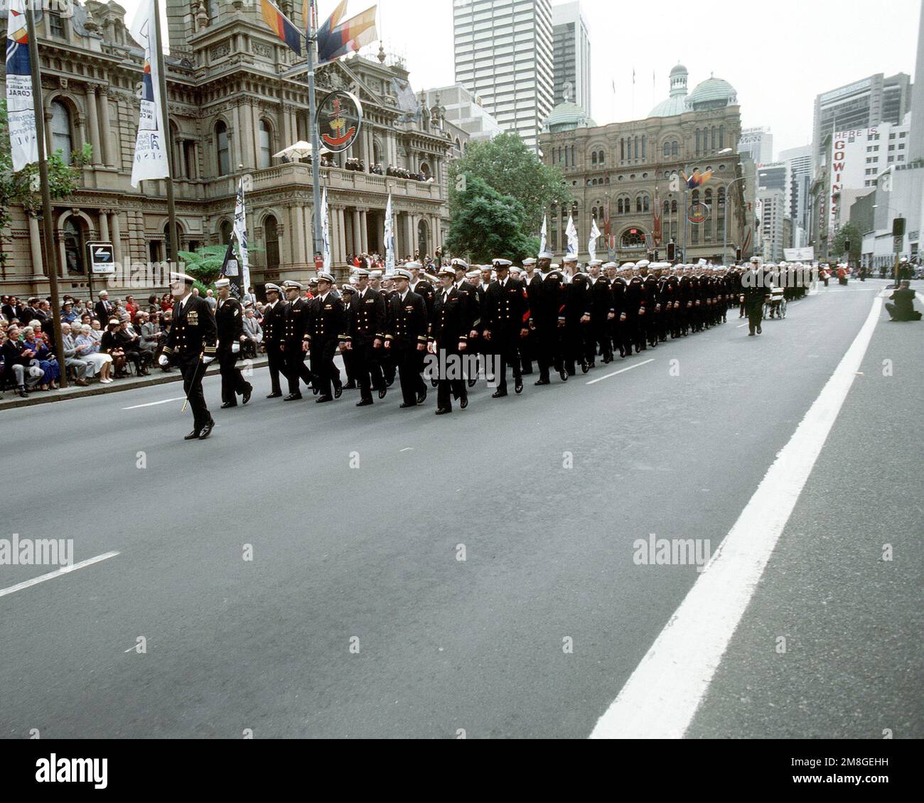 Members of the U.S. Navy march in a parade during ceremonies ...