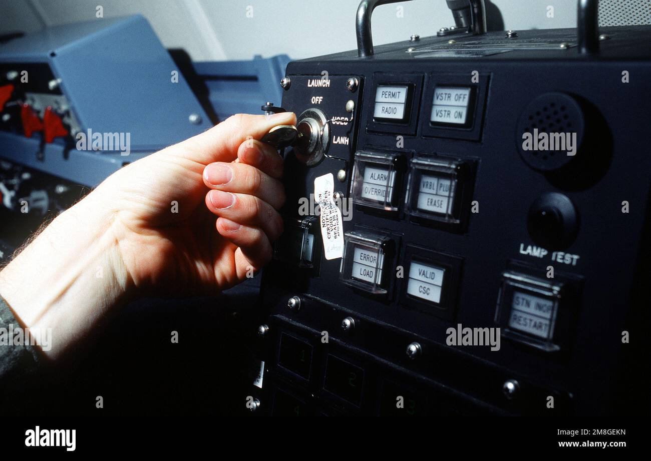 An airborne missile combat crew commander turns the missile launch key ...
