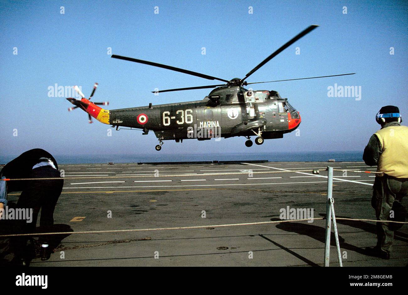 An SH-3 Sea King helicopter of the Italian navy prepares to touch down ...