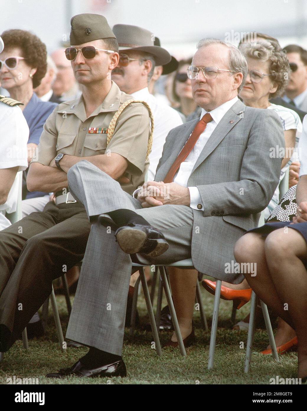 Secretary of the Navy H. Lawrence Garrett listens to a speaker during ...