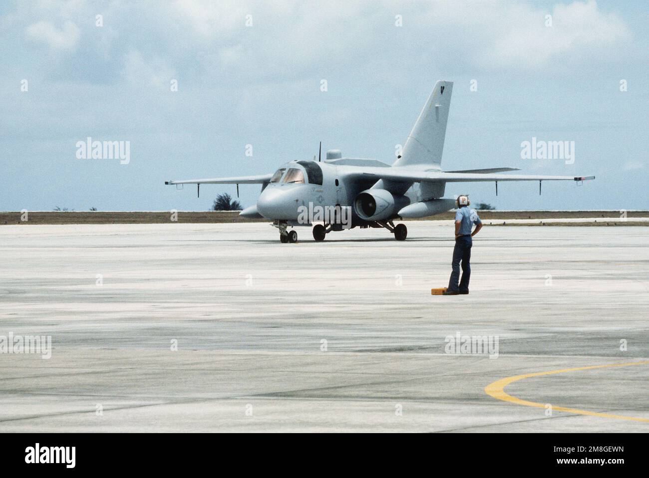 A ground crewman stands ready as the Navy's first operational ES-3A ...