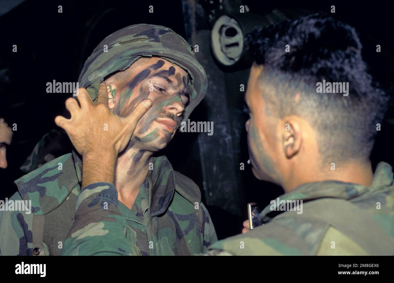 Members of the 2nd Marine Division help each other apply camouflage ...