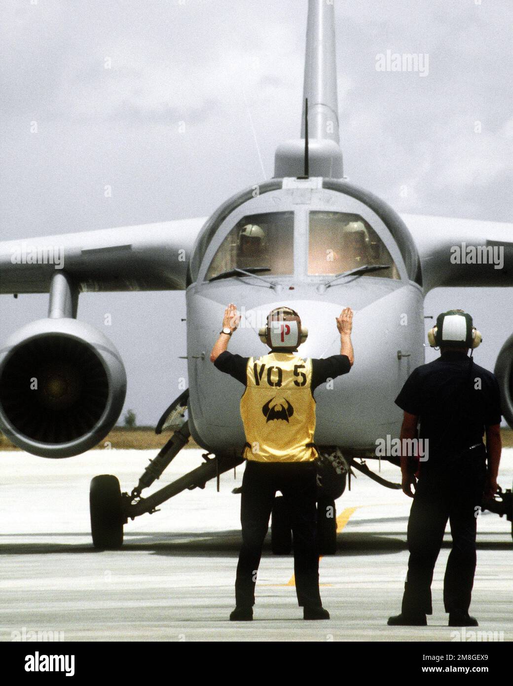 A Fleet Air Reconnaissance Squadron 5 (VQ-5) plane director gives the ...
