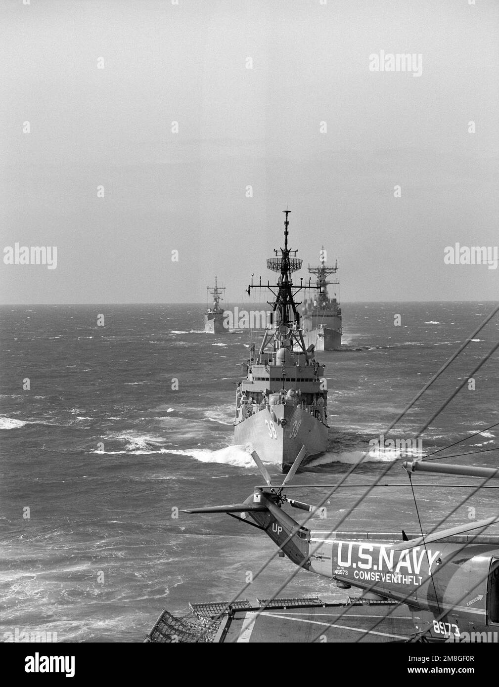 The Australian guided missile destroyer HMAS PERTH (DDG-38) follows the ...