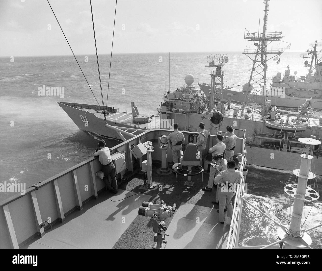 Sailors on the bridge wing of the U.S. Seventh Fleet Flagship USS BLUE ...